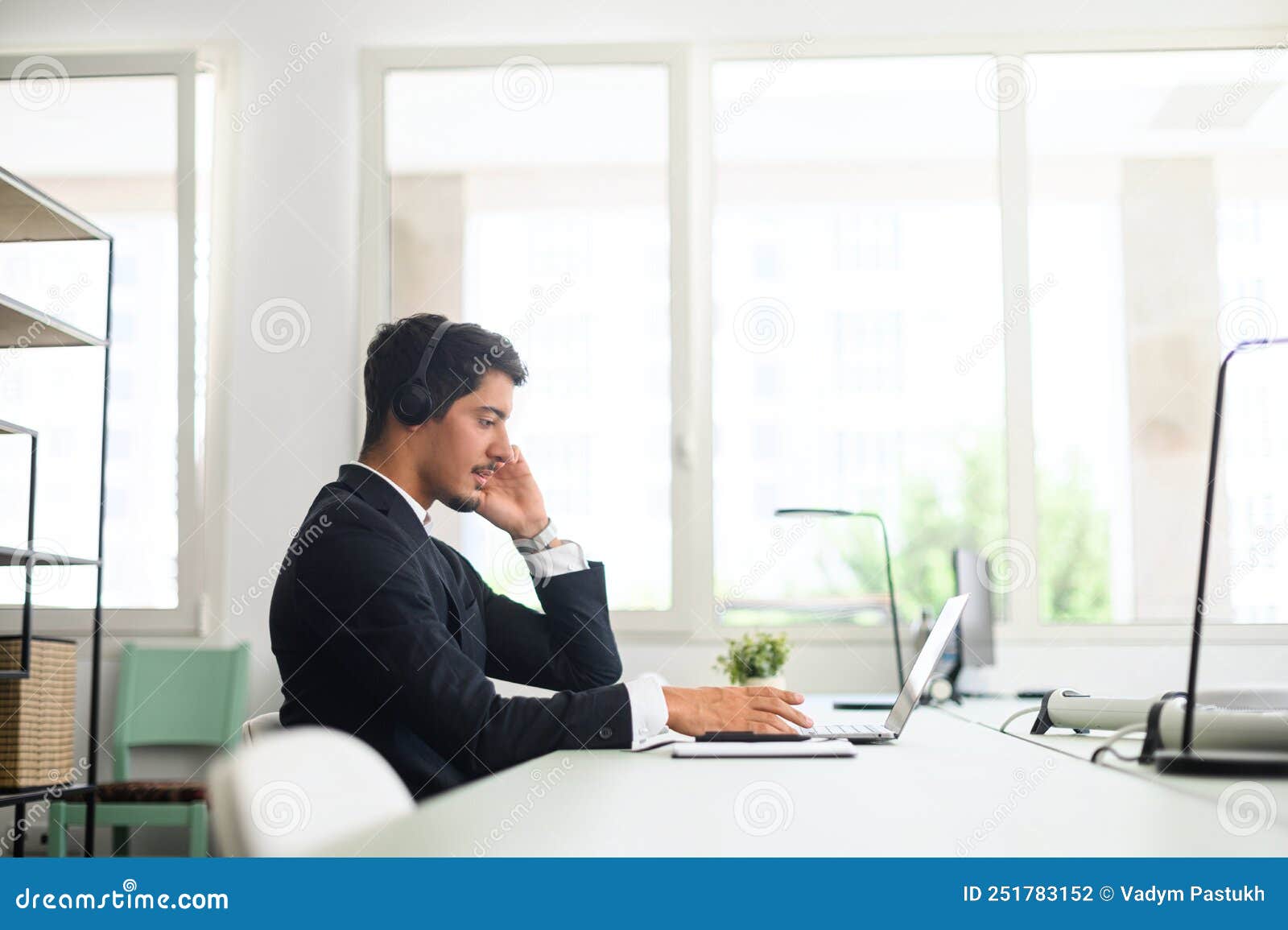 Confident Latin Male Office Worker Sitting at the Desk with a Laptop ...