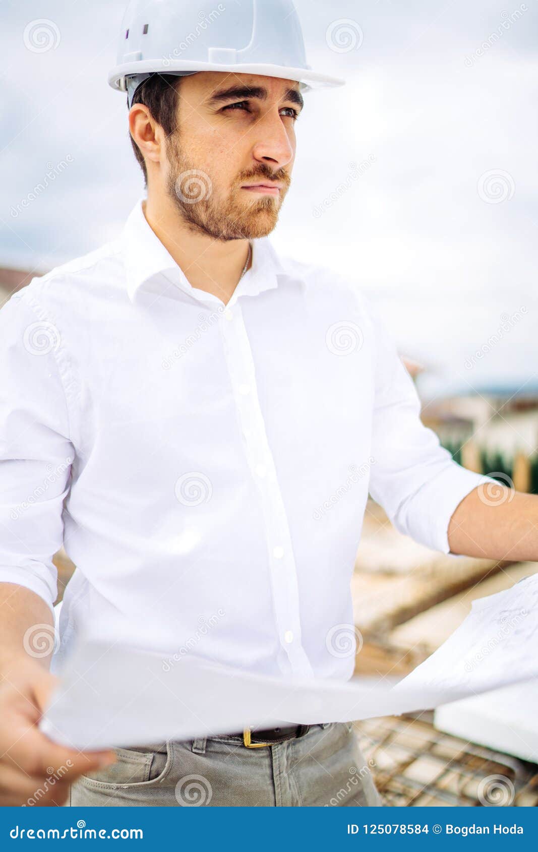 Male Architect Reading Blueprints on Construction Site Stock Photo ...