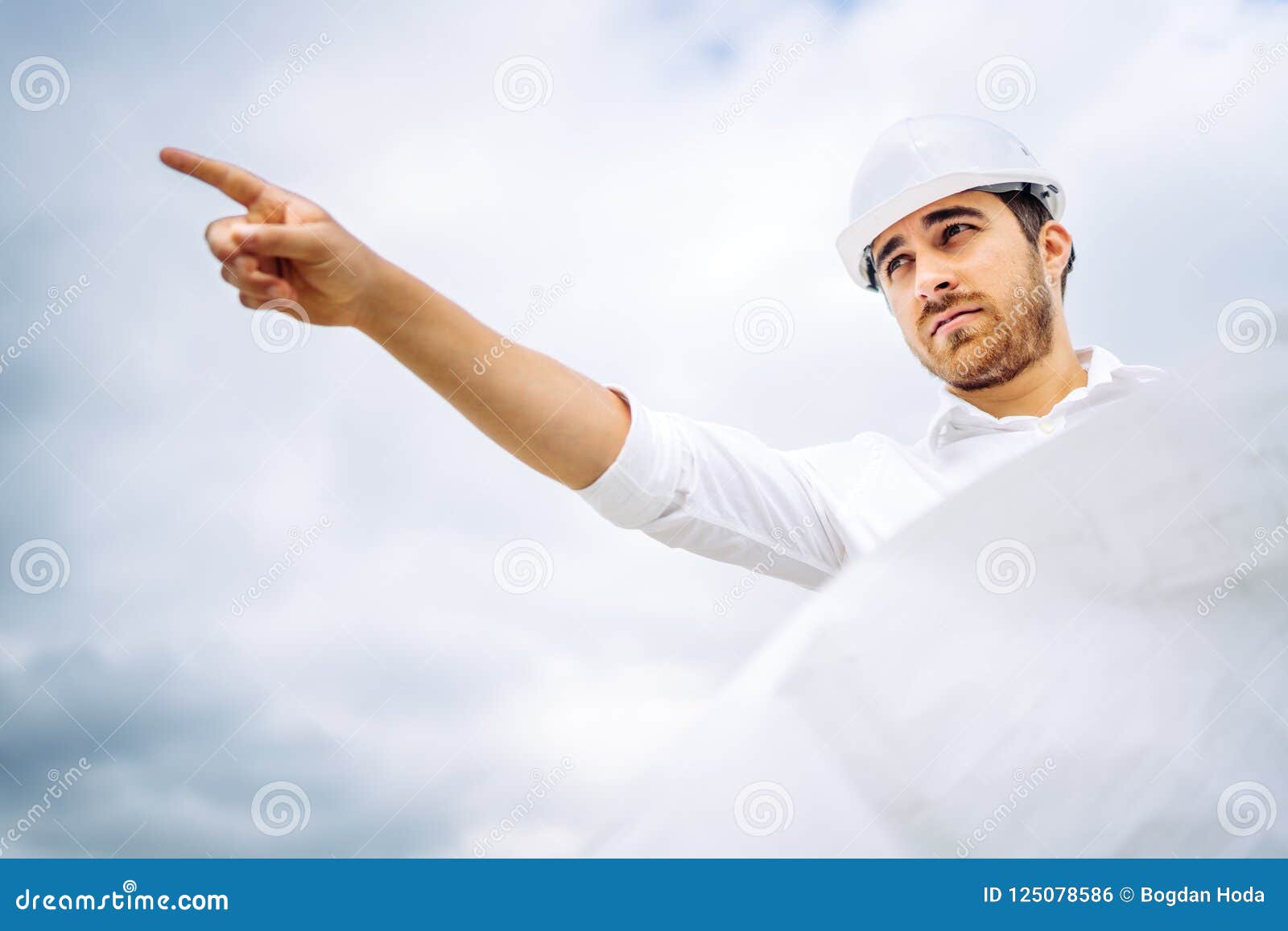 Male Architect Working and Pointing with Finger on Construction Site ...