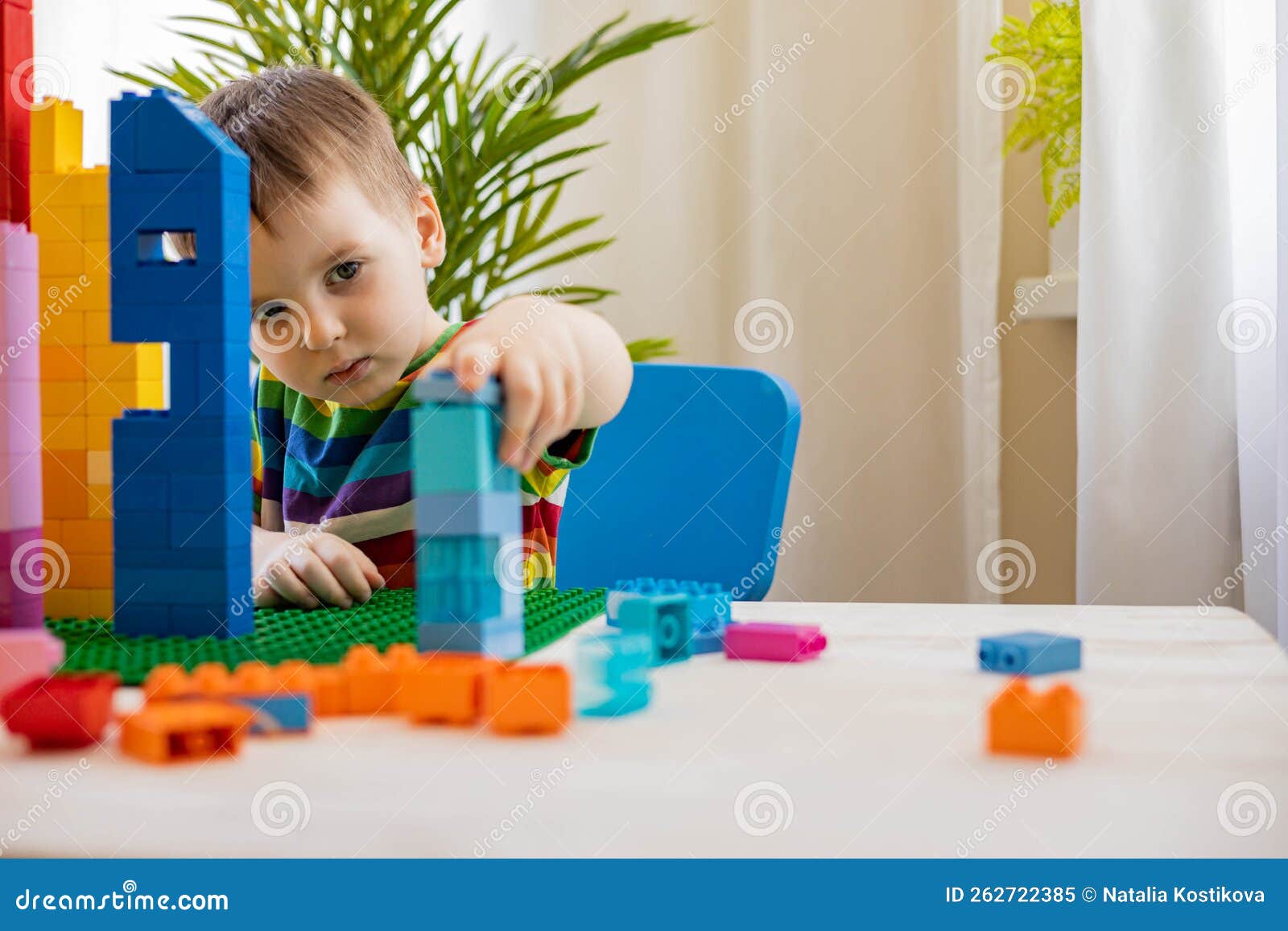 Confident Male Baby Constructing Tower with Multicolored Plastic Pieces ...