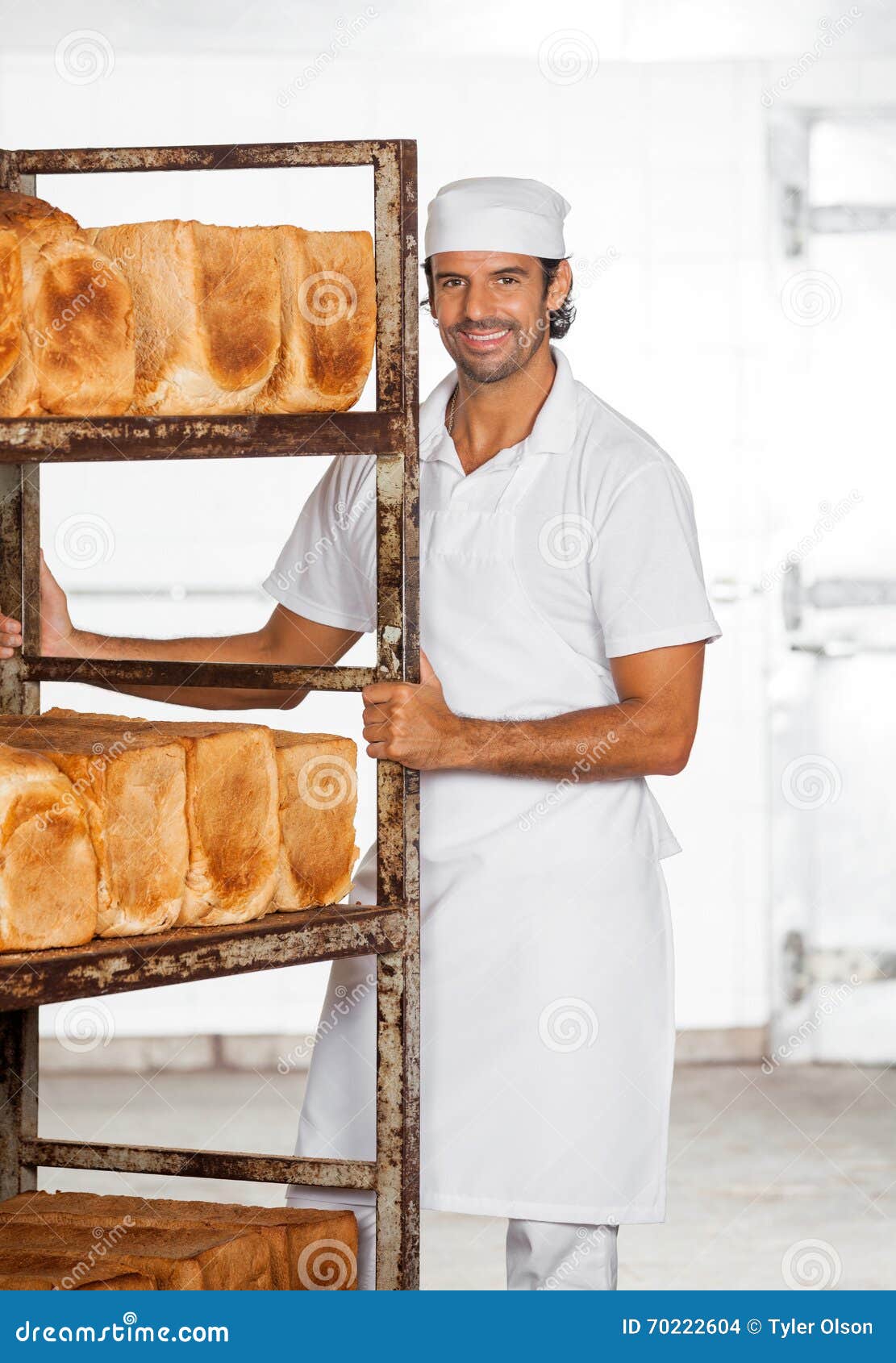 Confident Male Baker Standing by Bread Rack Stock Photo - Image of food ...