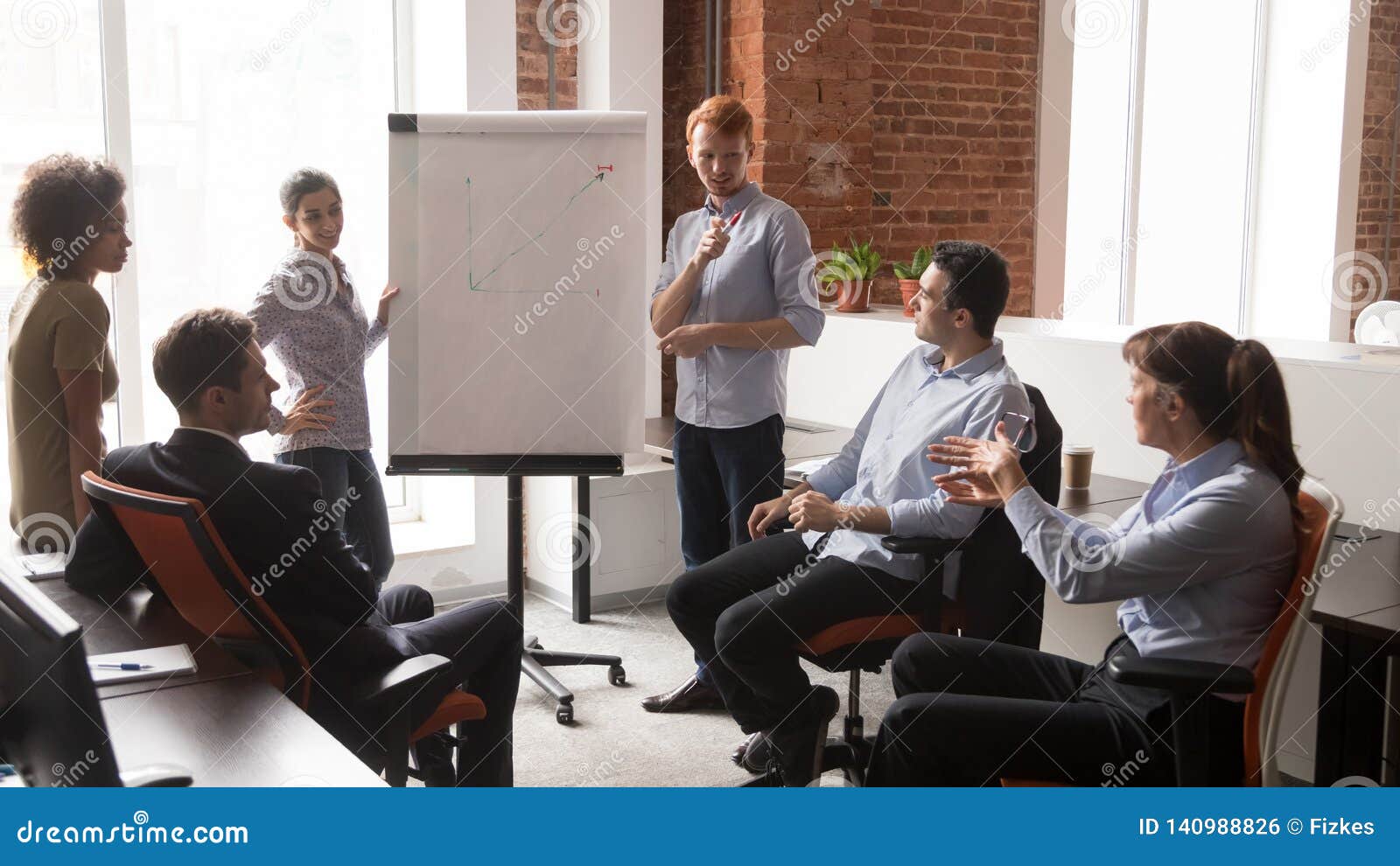 Confident Male Business Coach Speaker Giving Corporate Flip Chart ... Confident Male Business Coach Speaker Giving Corporate Flip Chart ...