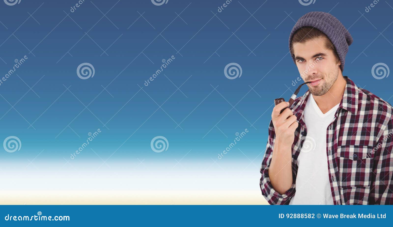 Confident Male Hipster Smoking Pipe Against Blue Background Stock Photo ...