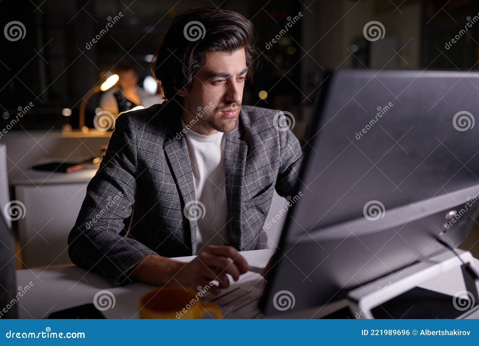 Confident Male Programmer Working on Computer at Night. Table Light ...