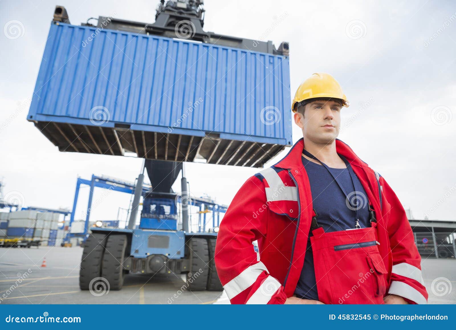 Confident Male Worker Standing in Front of Freight Vehicle at Shipyard ...
