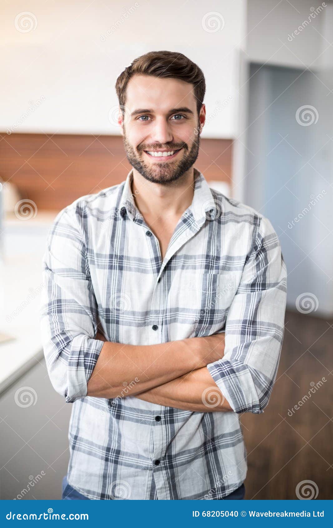 Confident Man with Arms Crossed by Kitchen Counter Stock Photo - Image ...