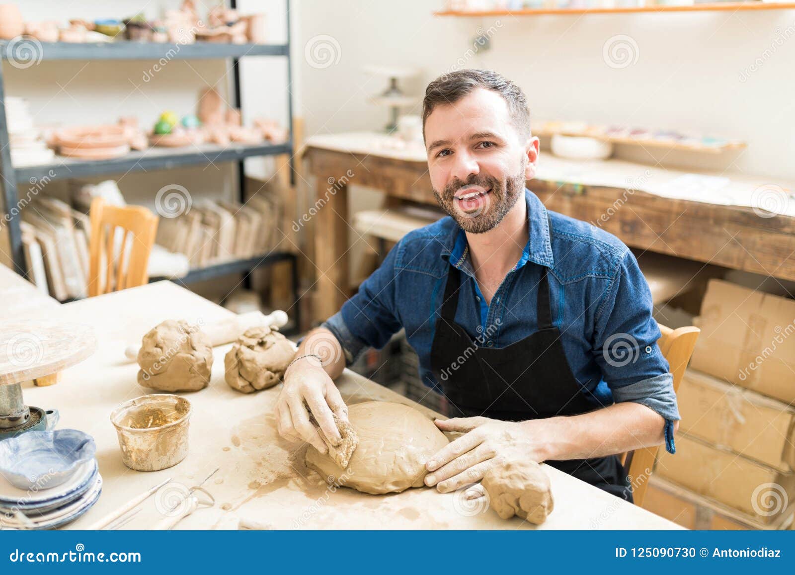 Confident Man Shaping Clay with Sponge in Pottery Class Stock Photo ...
