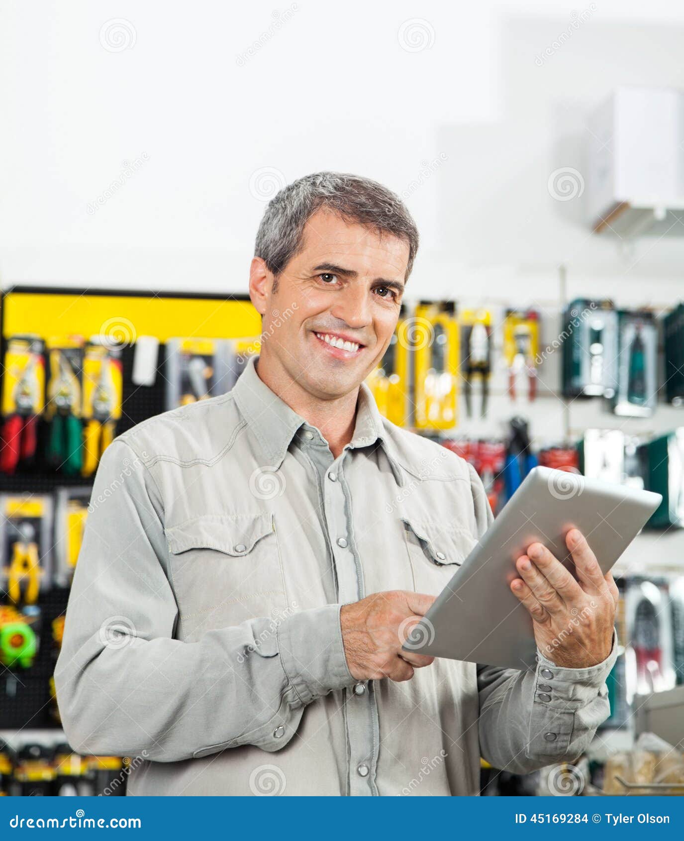 Confident Man Using Tablet Computer in Hardware Stock Photo - Image of ... Confident Man Using Tablet Computer in Hardware Stock Photo - Image of ...