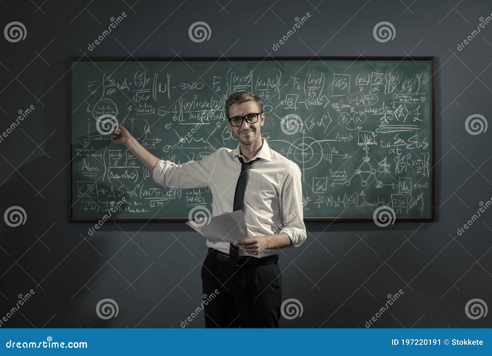 Confident Math Professor Teaching in Front of the Chalkboard Stock ...