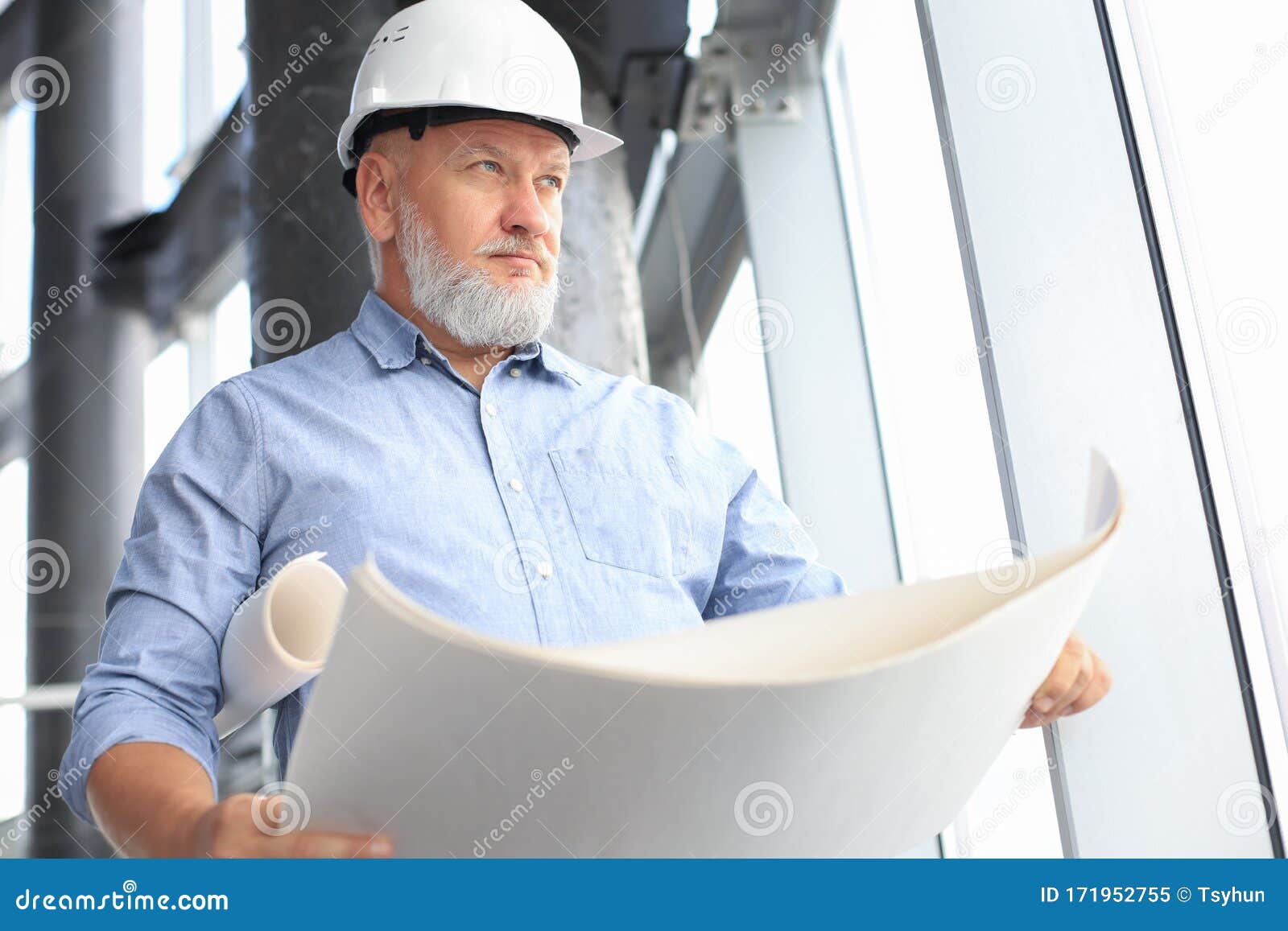 Confident Mature Architect in Corporate Suit and Hardhat Holding a ... Confident Mature Architect in Corporate Suit and Hardhat Holding a ...