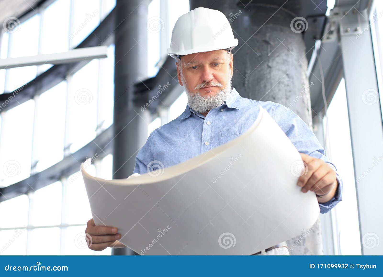 Confident Mature Architect in Corporate Suit and Hardhat Holding a ... Confident Mature Architect in Corporate Suit and Hardhat Holding a ...