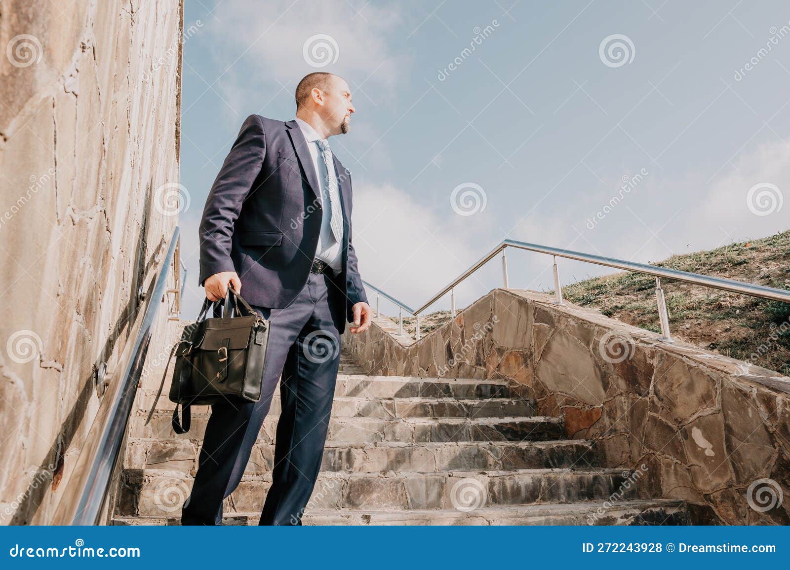 Confident Middle Age Businessman With Briefcase Walking Upstairs Close