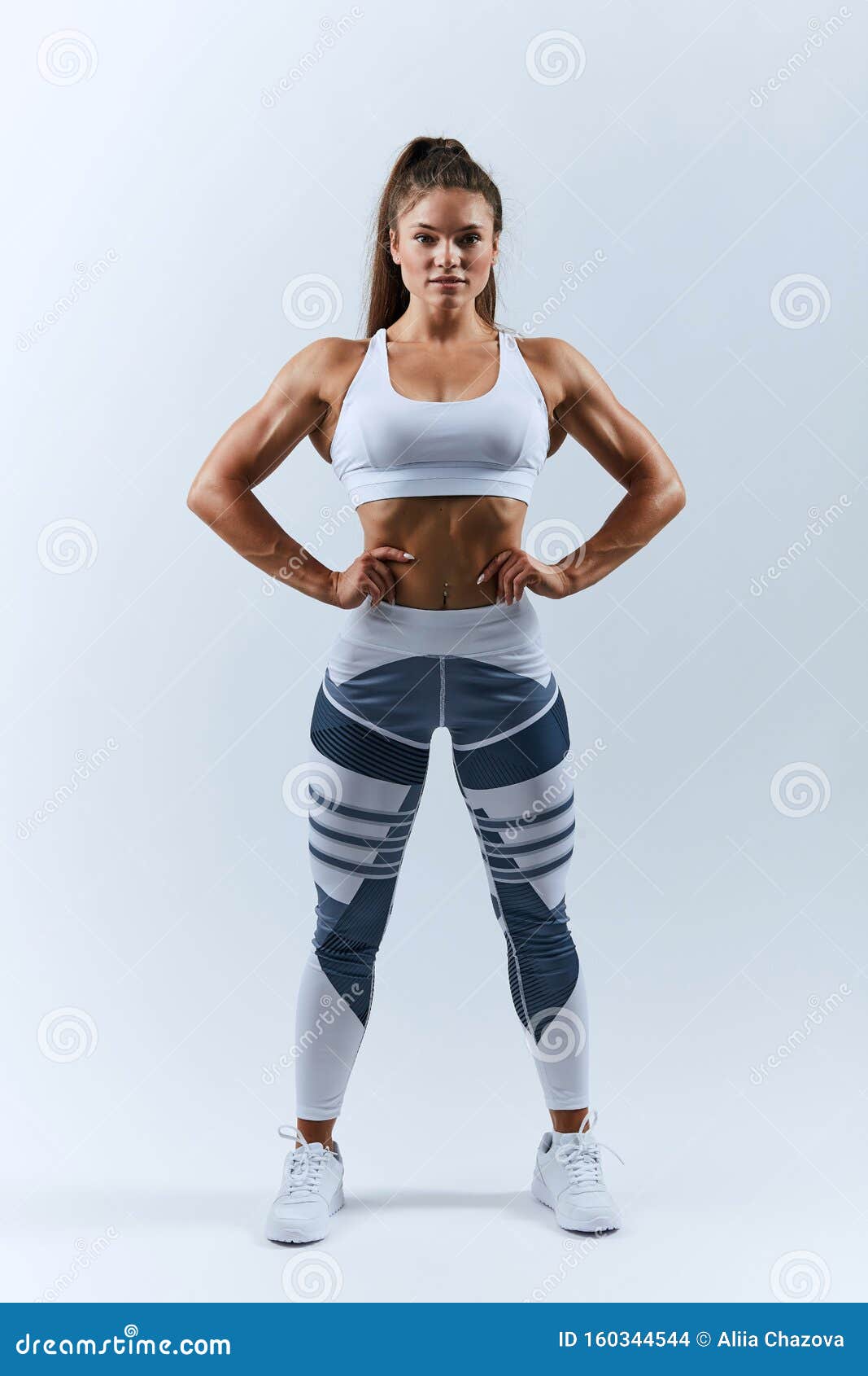 Confident Muscular Woman Standing with Hands on the Hips Stock Photo ... Confident Muscular Woman Standing with Hands on the Hips Stock Photo ...