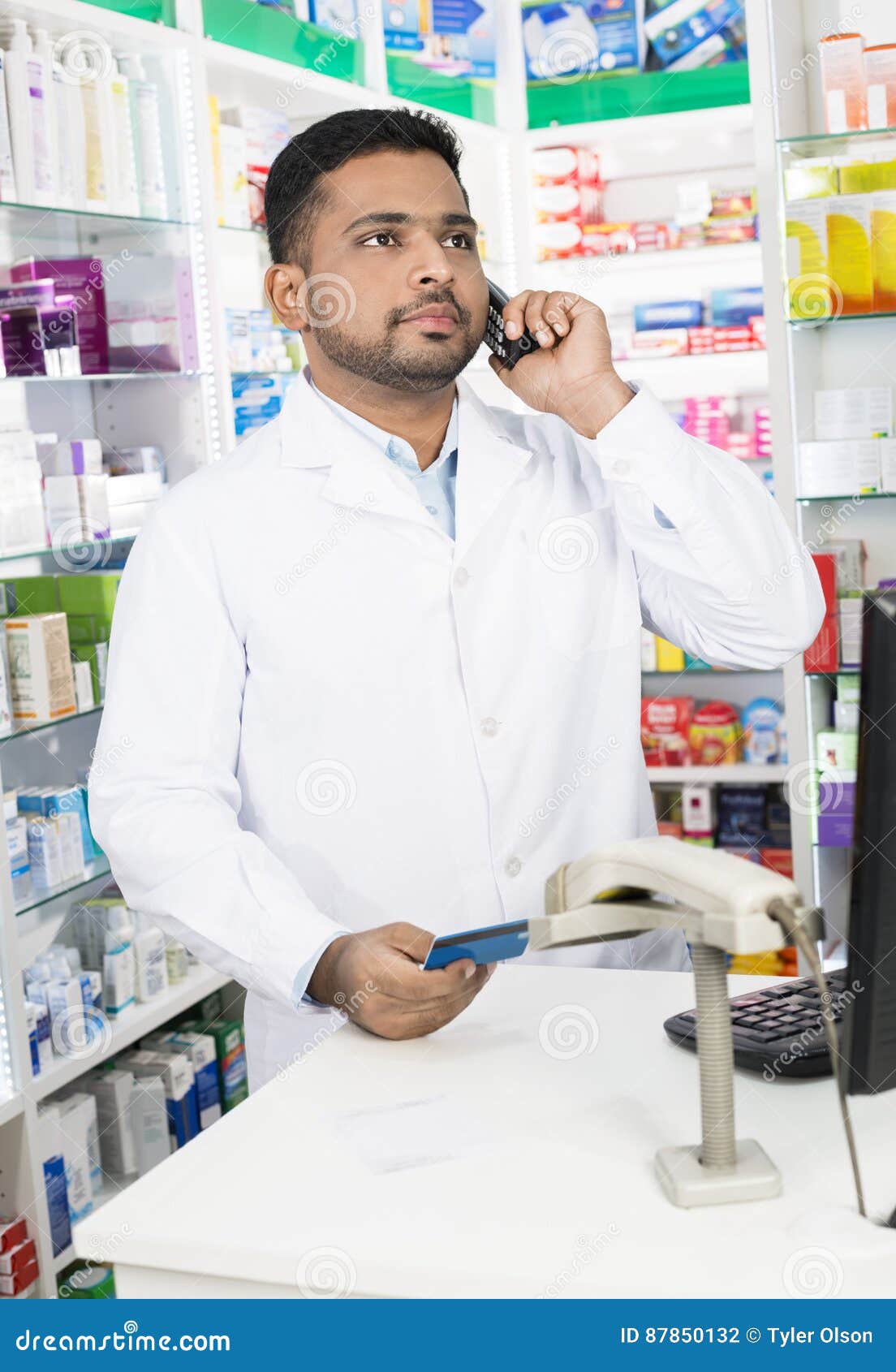 Confident Pharmacist Using Phone while Holding Credit Card Stock Photo ...