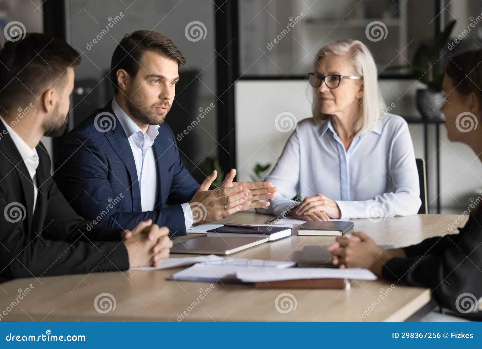 Confident Project Manager Man in Formal Suit Speaking To Colleagues ...