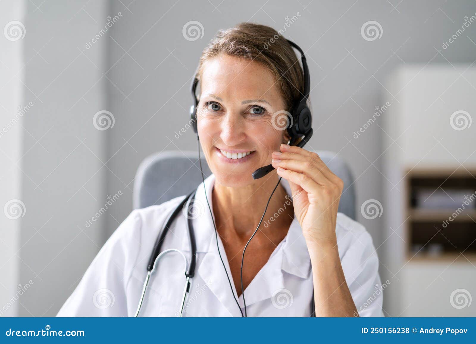 Confident Receptionist Using Headset in Hospital Stock Photo - Image of ...