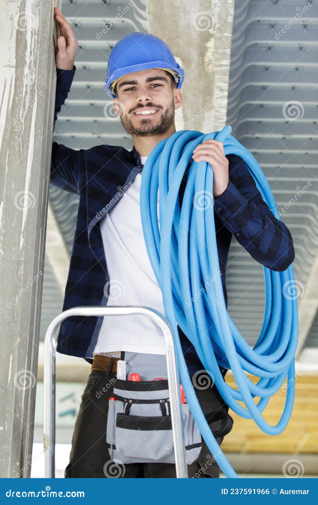 Confident Repairman Wearing Hard Hat while Holding Wire Roll Stock ...