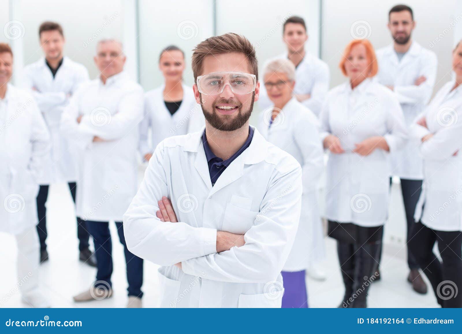 Confident Scientific Leader Standing in Front of a Team of Young ... Confident Scientific Leader Standing in Front of a Team of Young ...