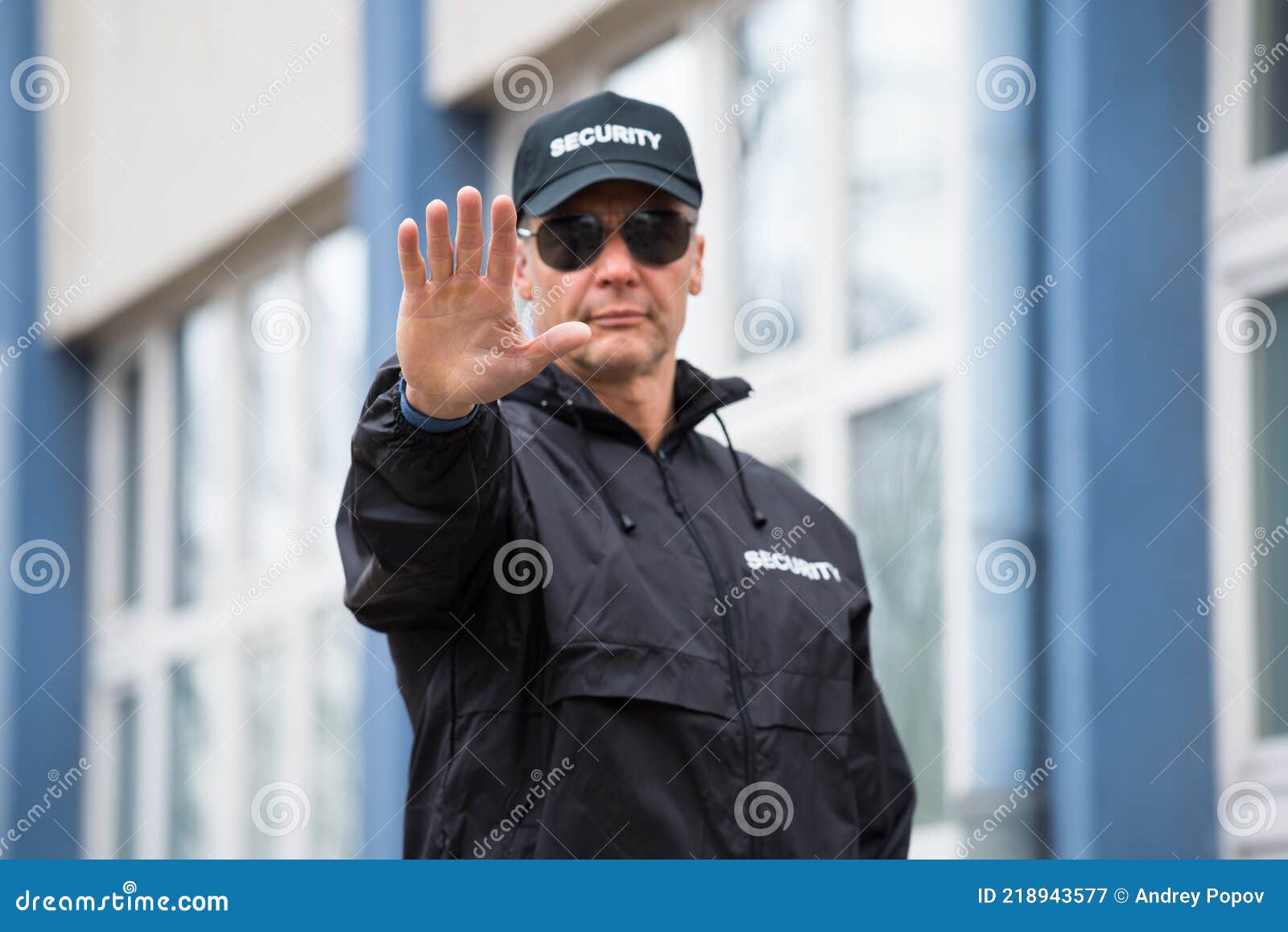 Security Guard Making Stop Gesture Outside Building Stock Image - Image ...