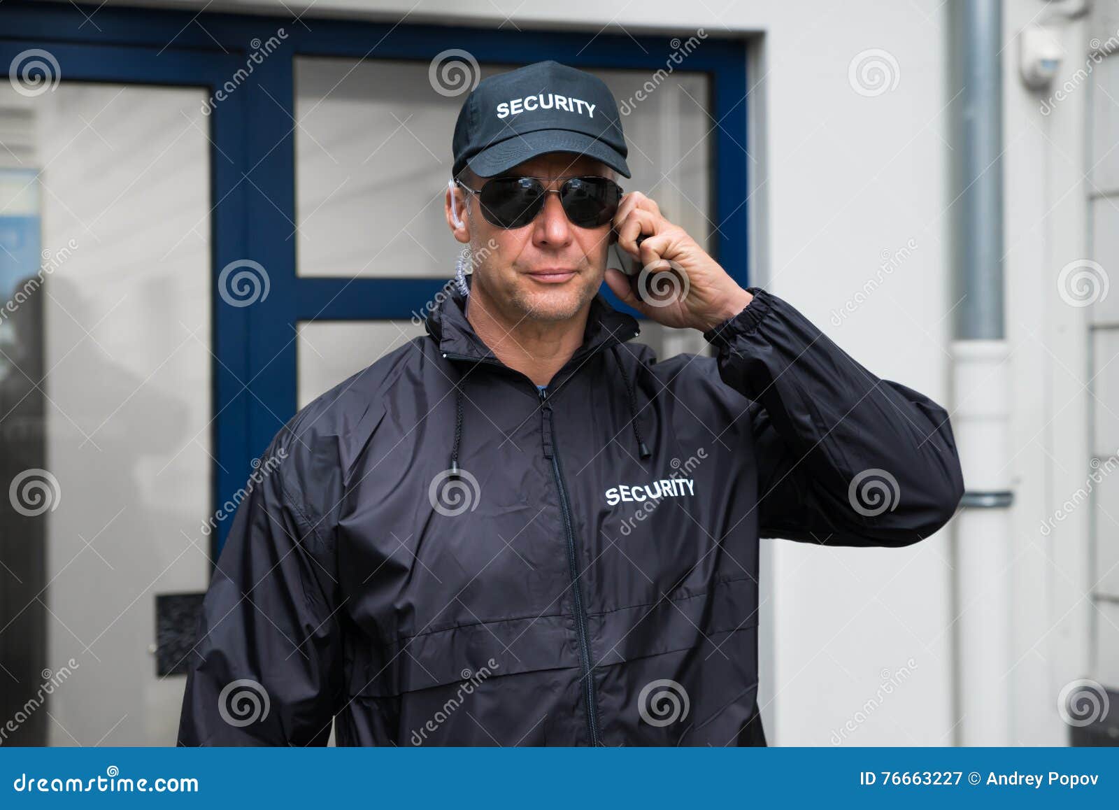 Confident Security Guard Using Mobile Phone Outside Building Stock ...