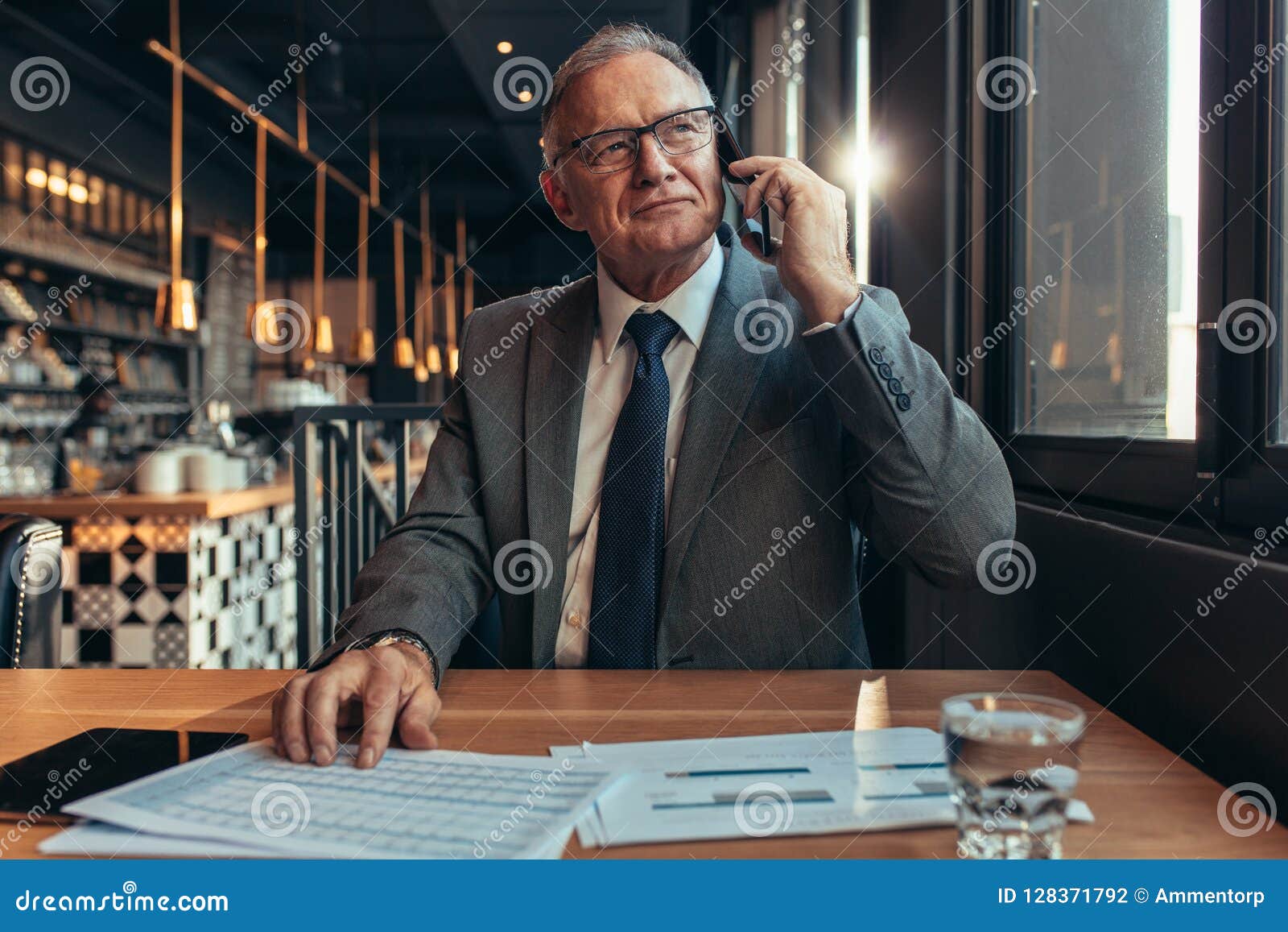 Confident Senior Businessman at Coffee Shop Using Phone Stock Photo ...
