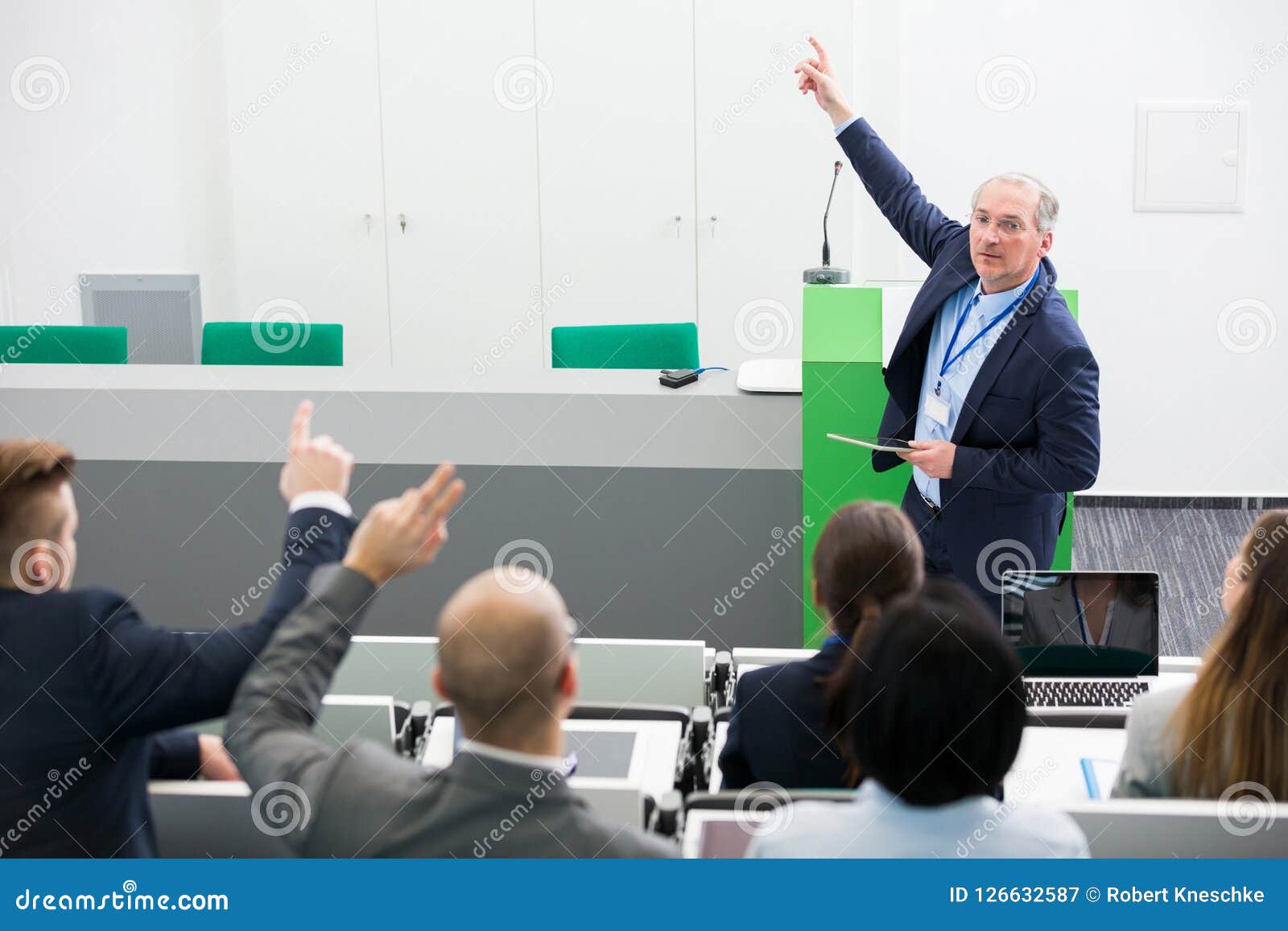 Confident Senior Businessman Giving Presentation To Colleagues Stock ... Confident Senior Businessman Giving Presentation To Colleagues Stock ...