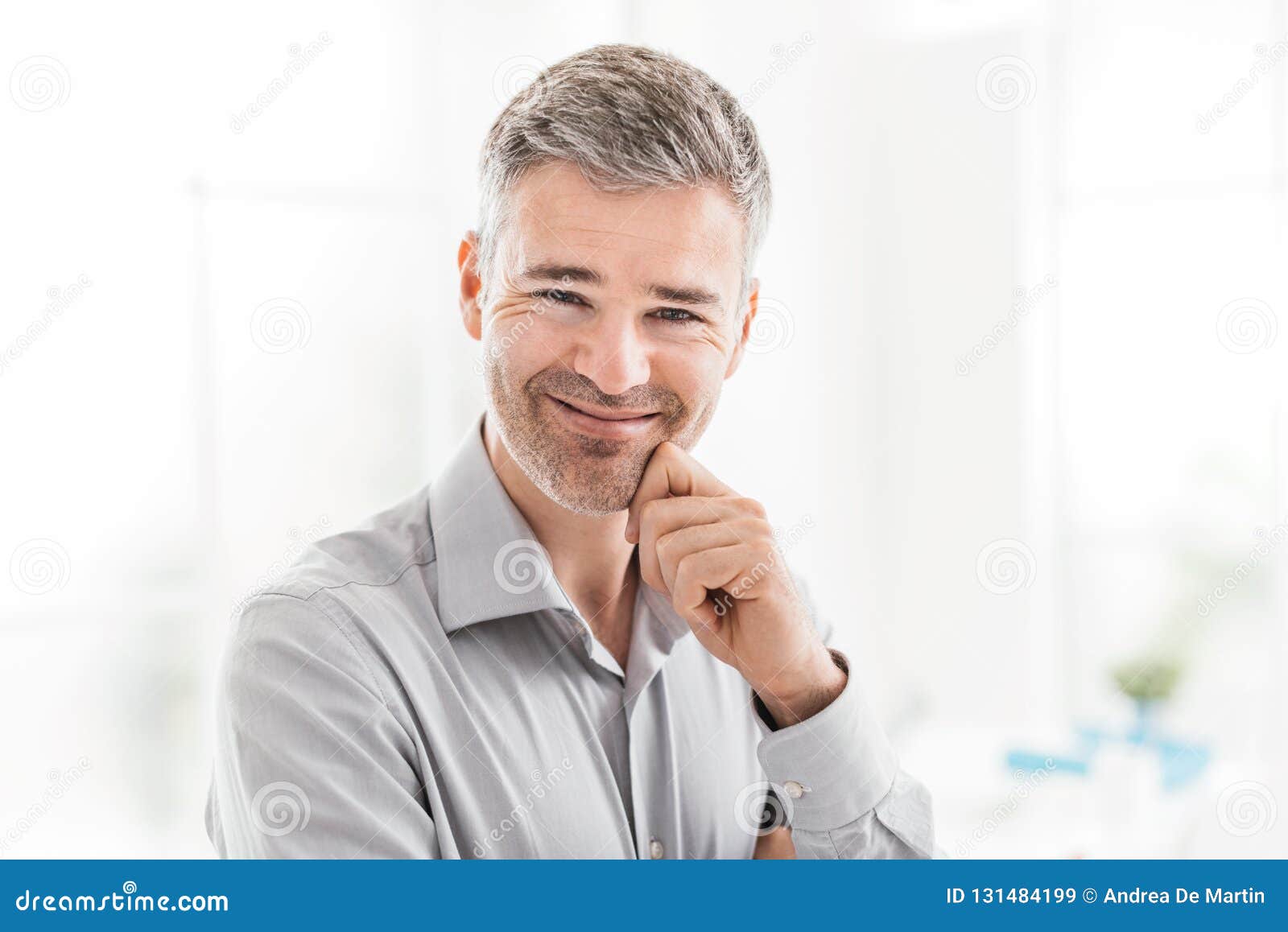 Confident Smiling Man Posing in the Office and Smiling at Camera Stock ...