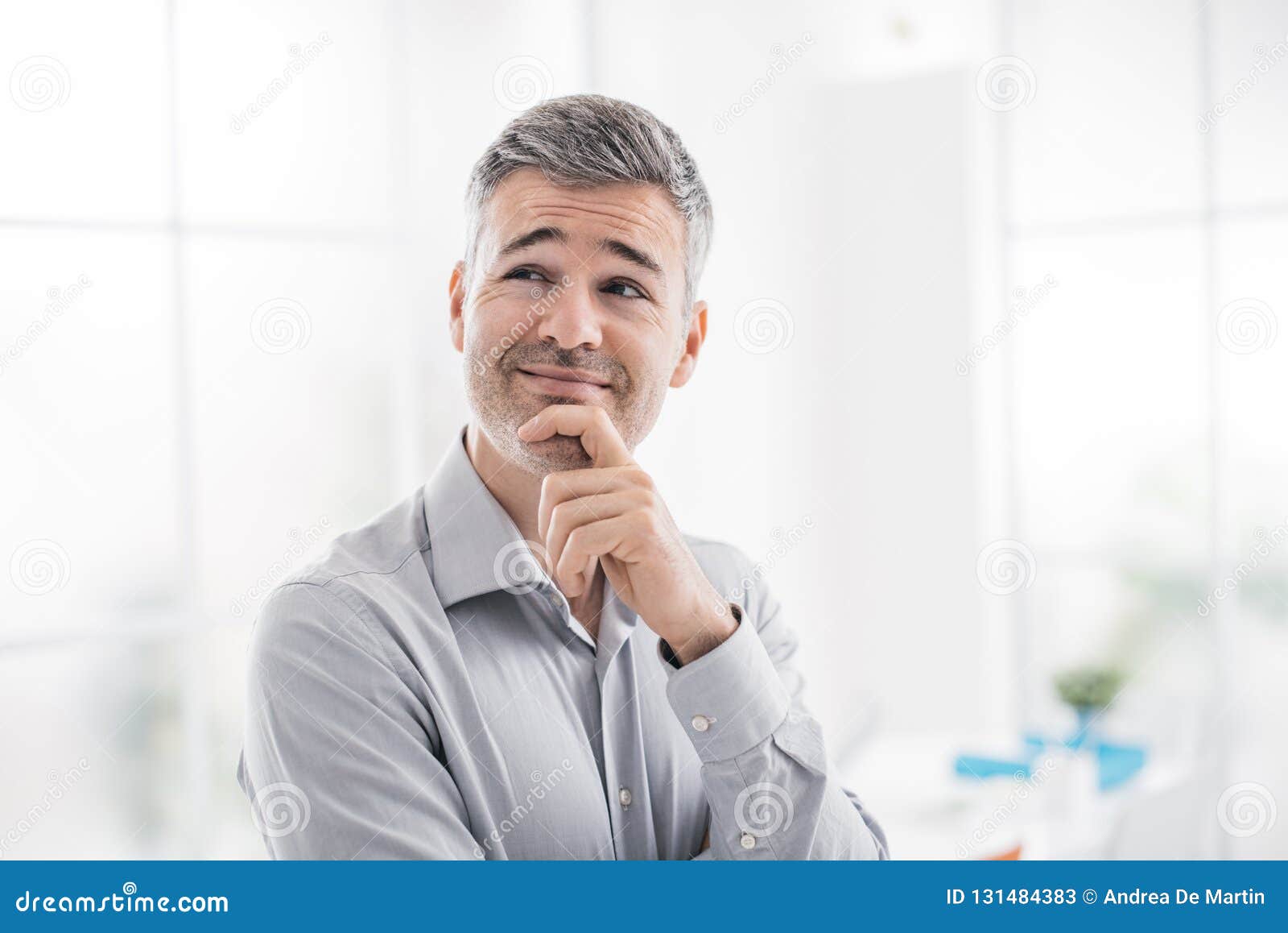 Confident Smiling Man Posing and Smiling at Camera, he is Thinking with ...