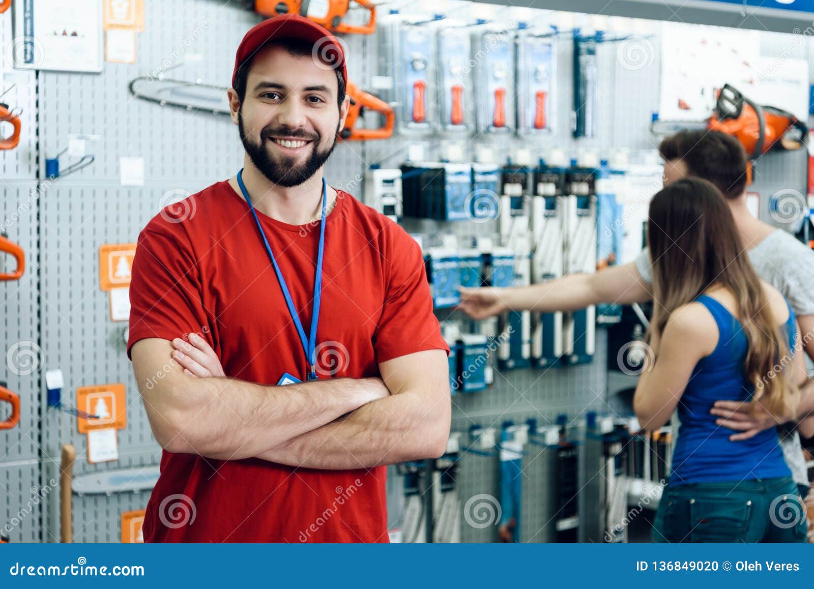 Confident Smiling Salesman in Power Tools Store. Guy is Ready To Help ...