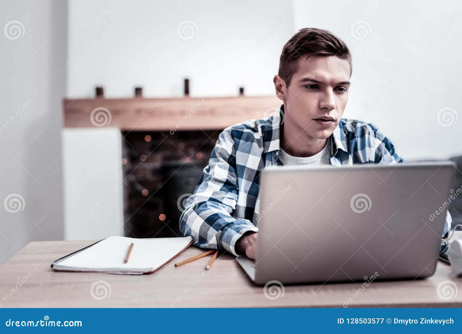 Confident Student Looking for Information when Using His Laptop Stock ...