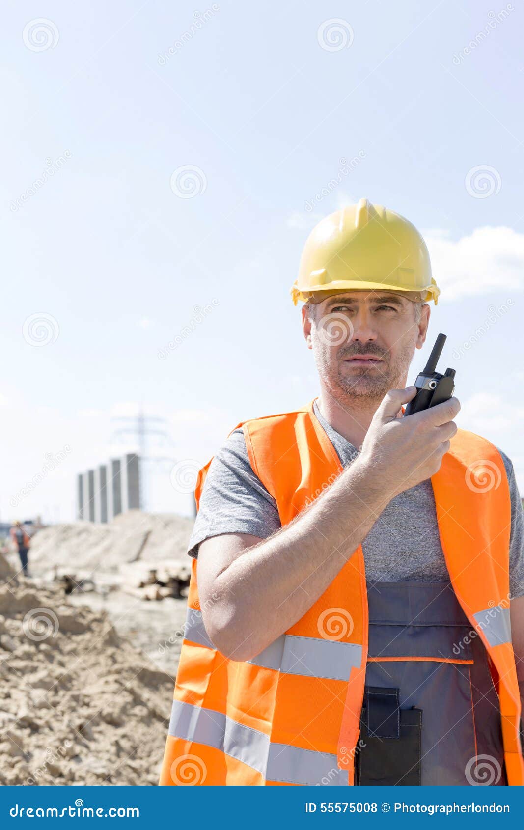 Confident Supervisor Using Walkie-talkie at Construction Site Against ...