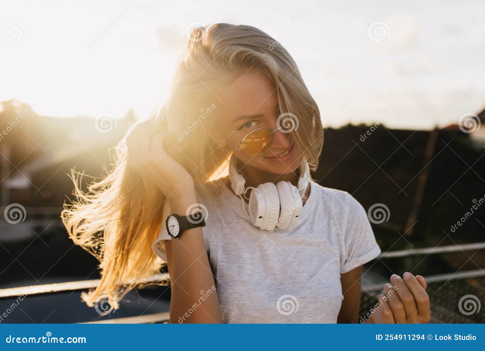 Confident Tanned Woman Playing With Her Hair In Sunny Day Outdoor