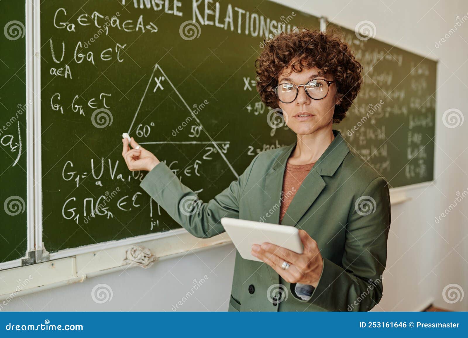 Confident Teacher of Geometry Pointing at Triangle on Blackboard Stock ...