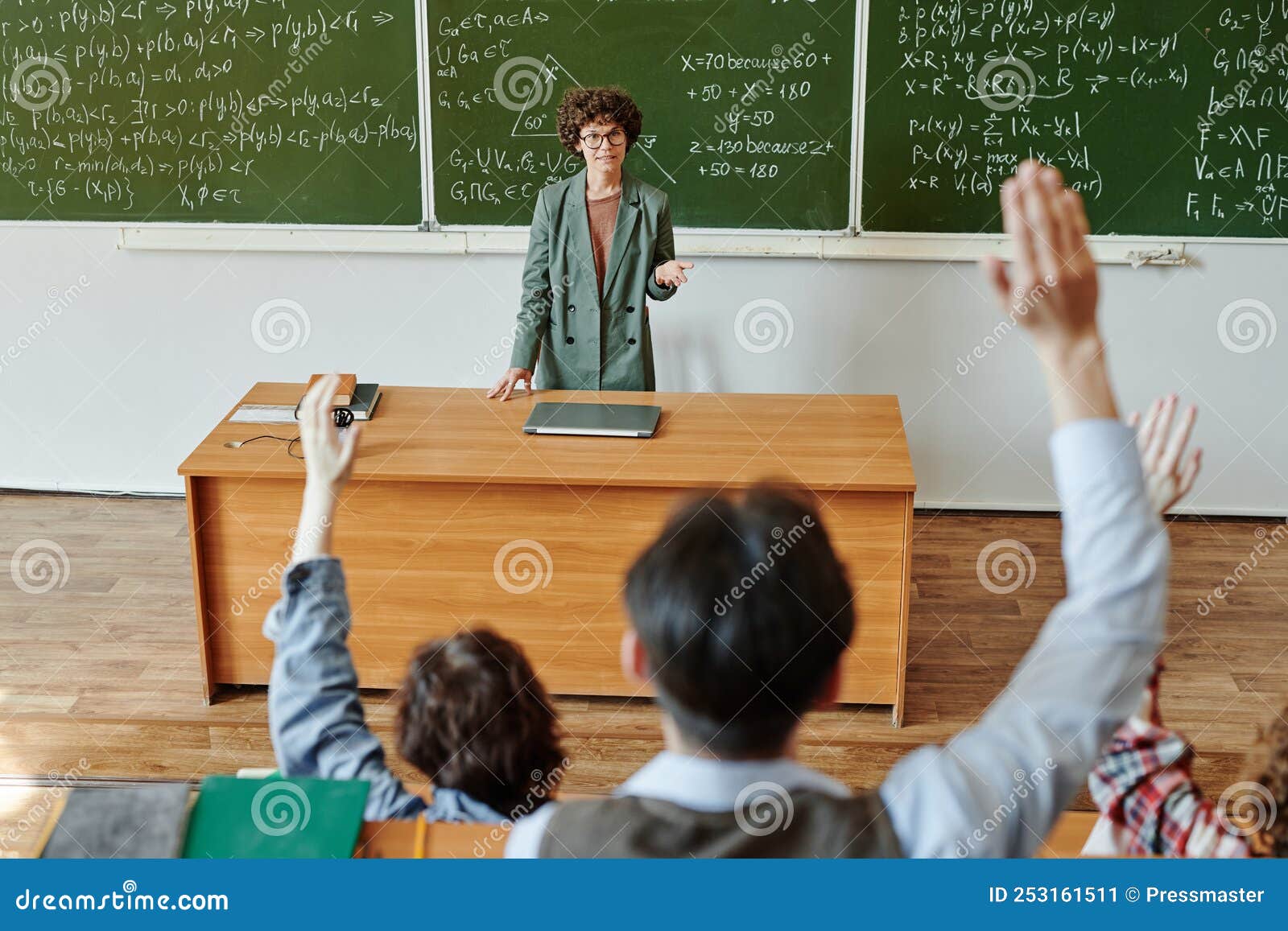 Confident Teacher Standing by Blackboard with Formulas and Equations ...