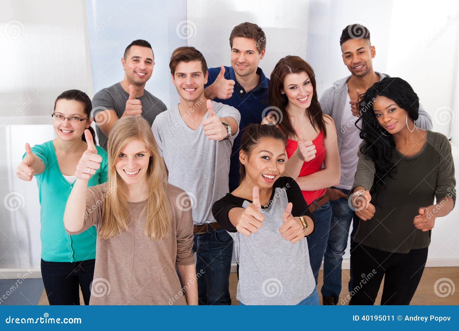 Confident University Students Gesturing Thumbs Up Stock Image - Image ...