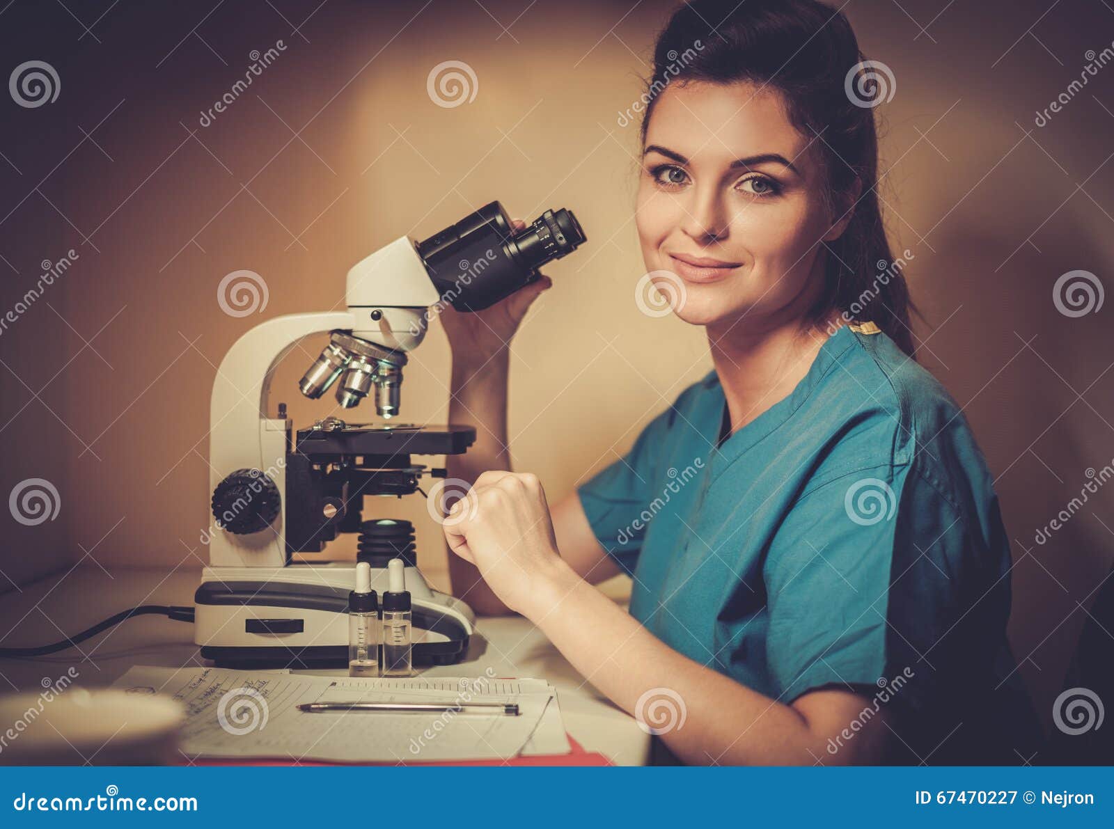 Confident Vet Examining the Test Under the Microscope in Veterinary ...