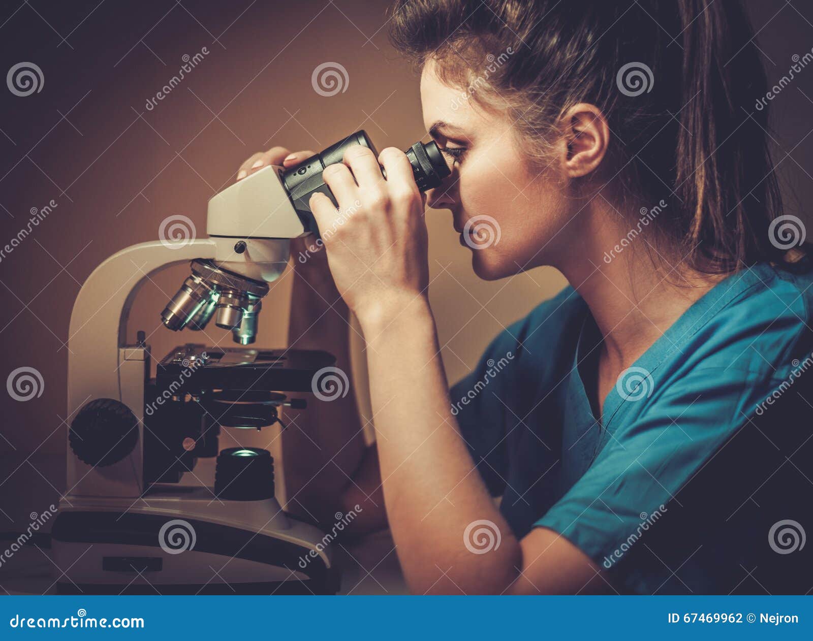 Confident Veterinarian Examining the Test Under the Microscope in ...