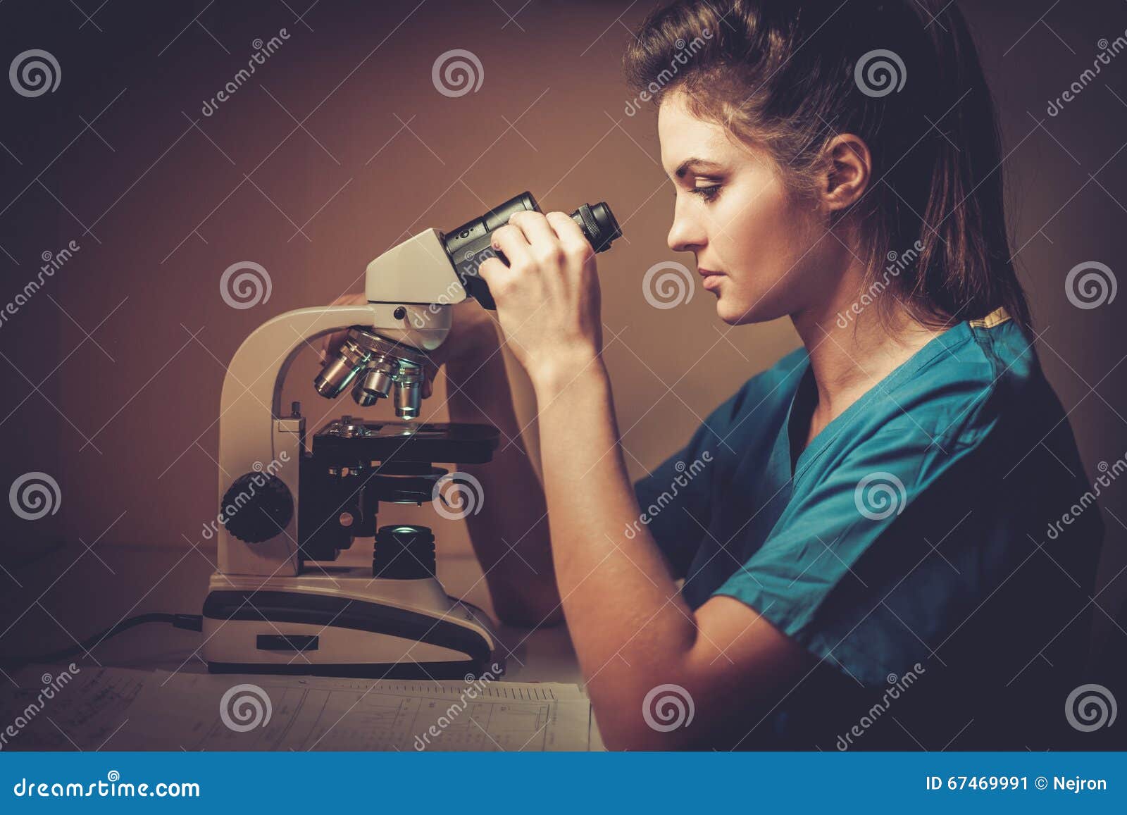 Confident Veterinarian Examining the Test Under the Microscope in ...