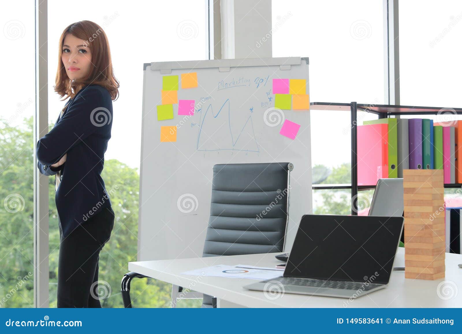 Confident Young Asian Executive Woman Standing in Office. Thoughtful ... Confident Young Asian Executive Woman Standing in Office. Thoughtful ...