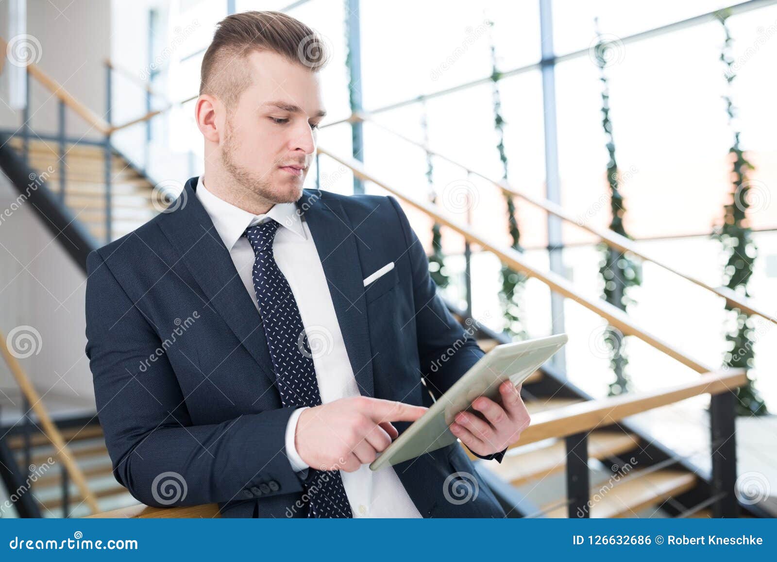 Businessman Using Tablet Computer while Leaning on Railing Stock Photo ... Businessman Using Tablet Computer while Leaning on Railing Stock Photo ...