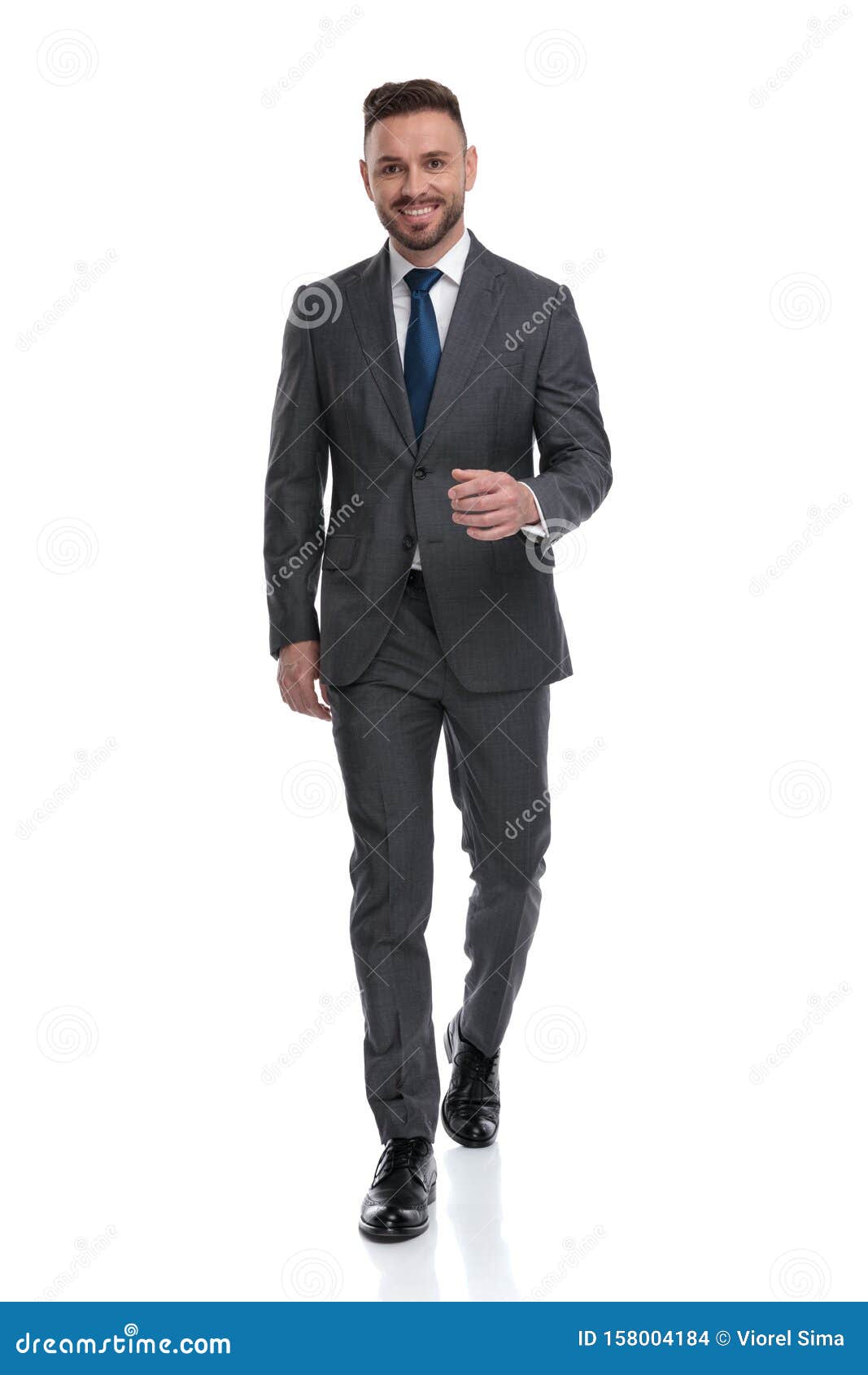 Confident Young Businessman Wearing Suit And Tie Is Walking Forward ... Confident Young Businessman Wearing Suit And Tie Is Walking Forward ...