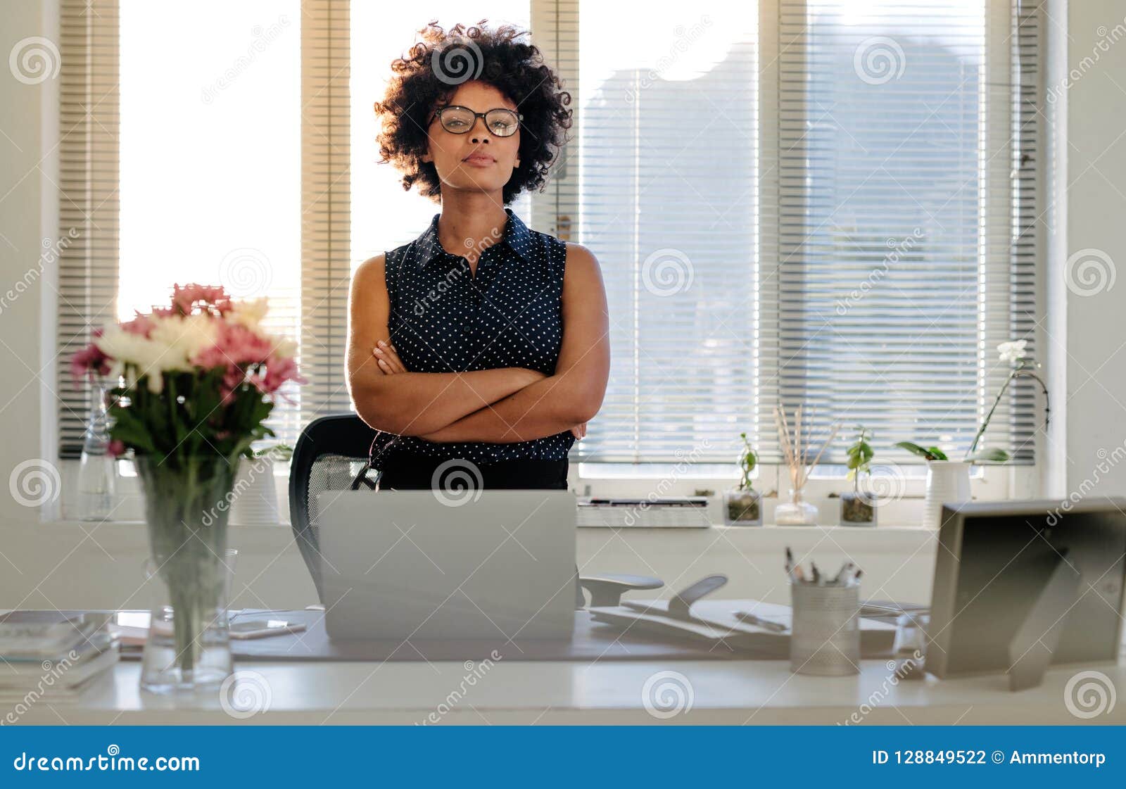 Confident Young Businesswoman Standing at Her Desk Stock Photo - Image ... Confident Young Businesswoman Standing at Her Desk Stock Photo - Image ...