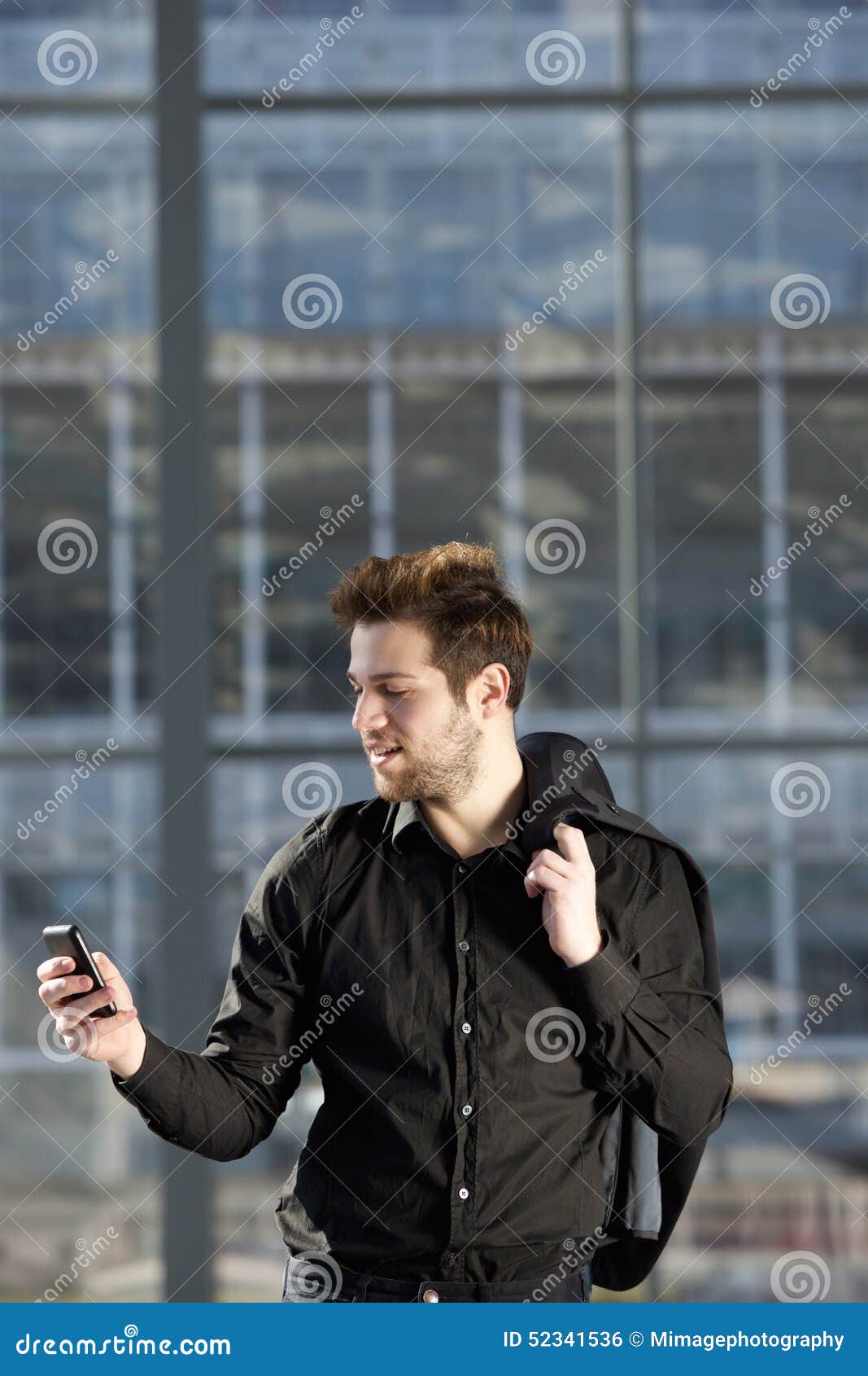 Confident Young Man Reading Text Message on Mobile Phone Stock Photo ...