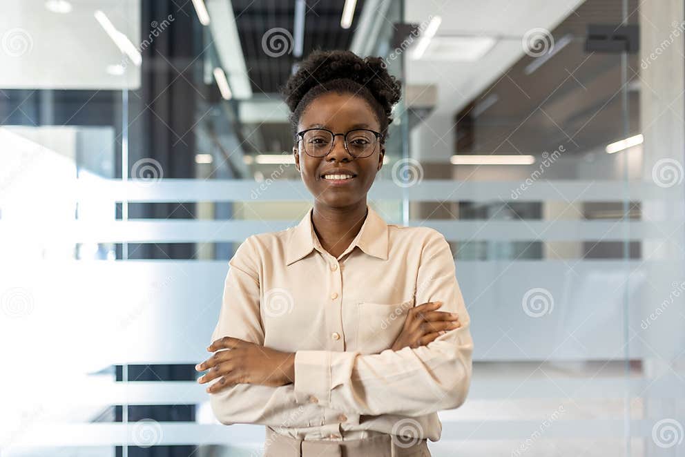 Confident Young Professional Woman Standing with Arms Crossed in Modern ... Confident Young Professional Woman Standing with Arms Crossed in Modern ...