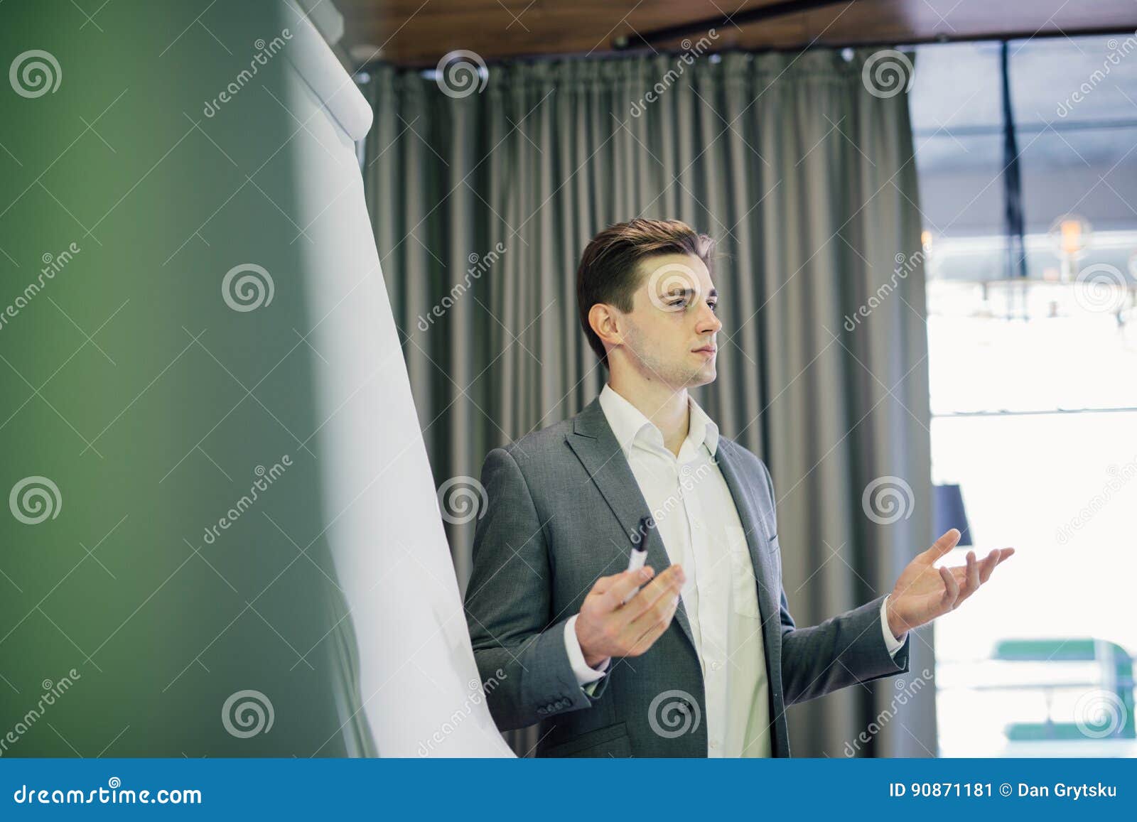 Confident Young Team Leader or Manager Standing in Front of a Flip ...