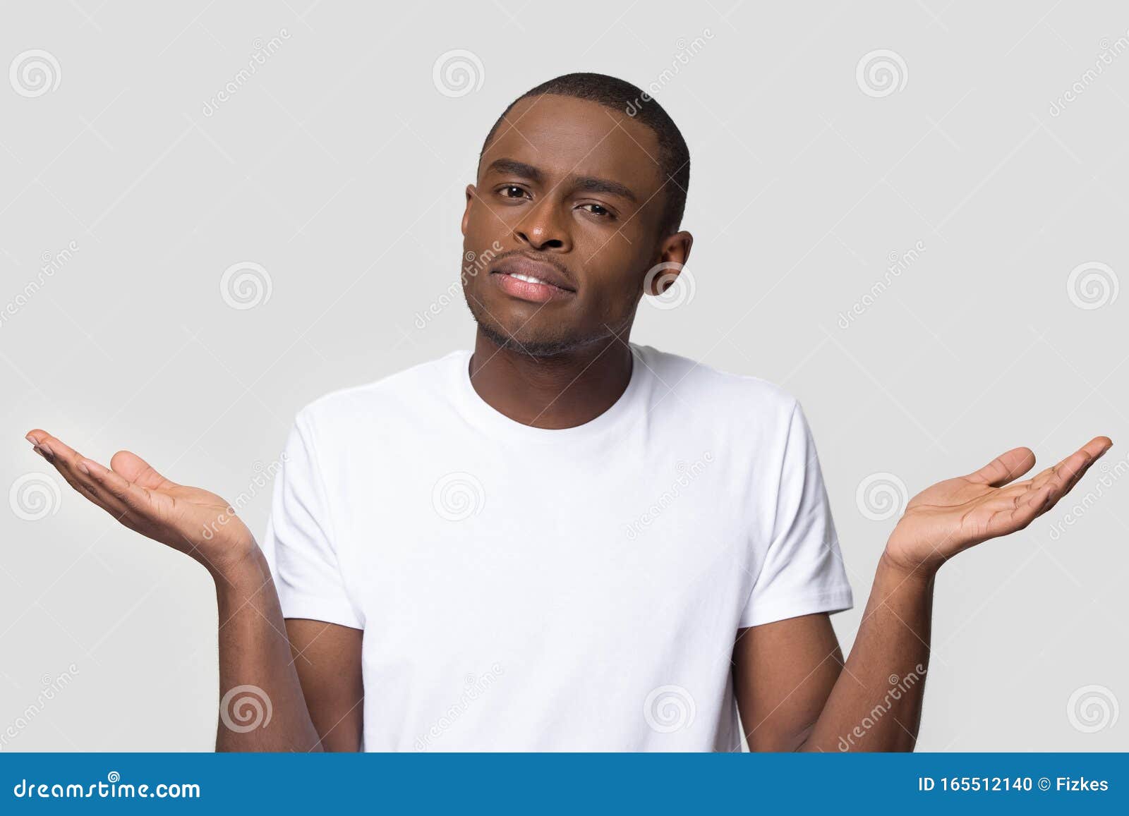 Confused African Man Raising Palms In Surrender Shrugging And Making
