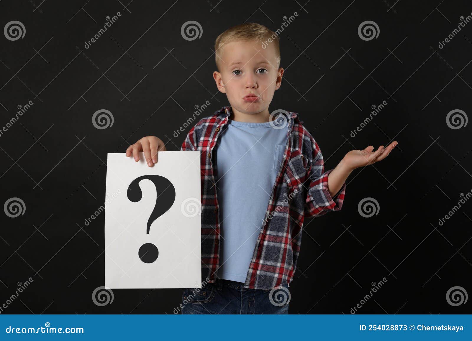 Confused Boy Holding Sheet of Paper with Question Mark on Black ...