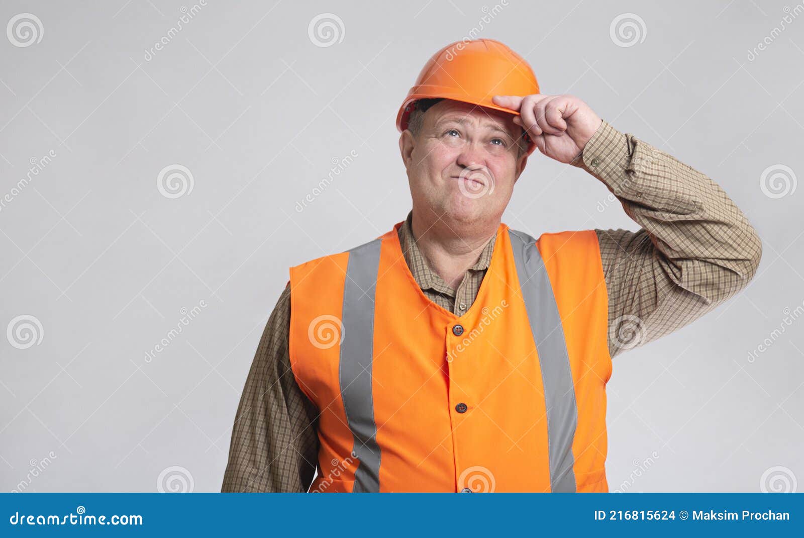 Confused Builder in Ard Hat on Grey Studio Background , Foreman ...