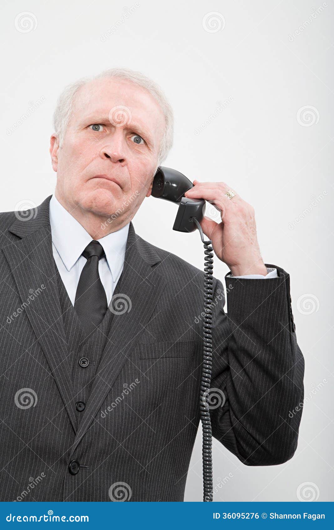 A Confused Businessman Using a Telephone Stock Photo - Image of ...