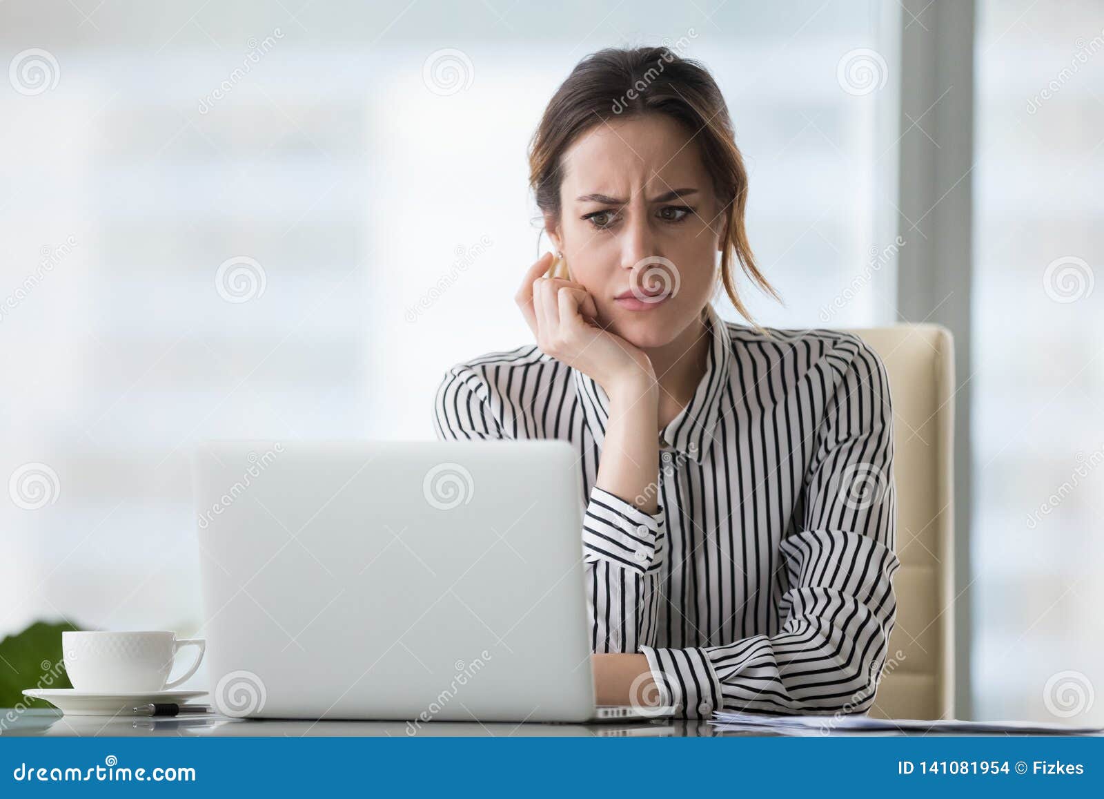 Confused Businesswoman Annoyed By Online Problem Looking At Laptop